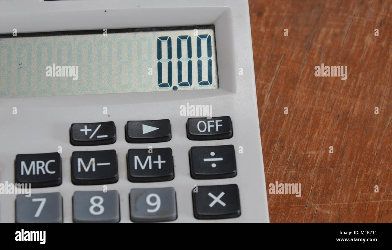 white calculator on wooden desk Stock Photo - Alamy