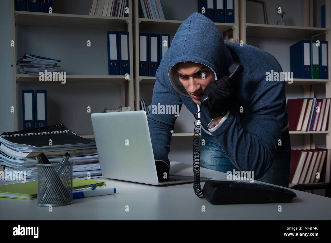 Young hacker hacking into computer at night Stock Photo - Alamy