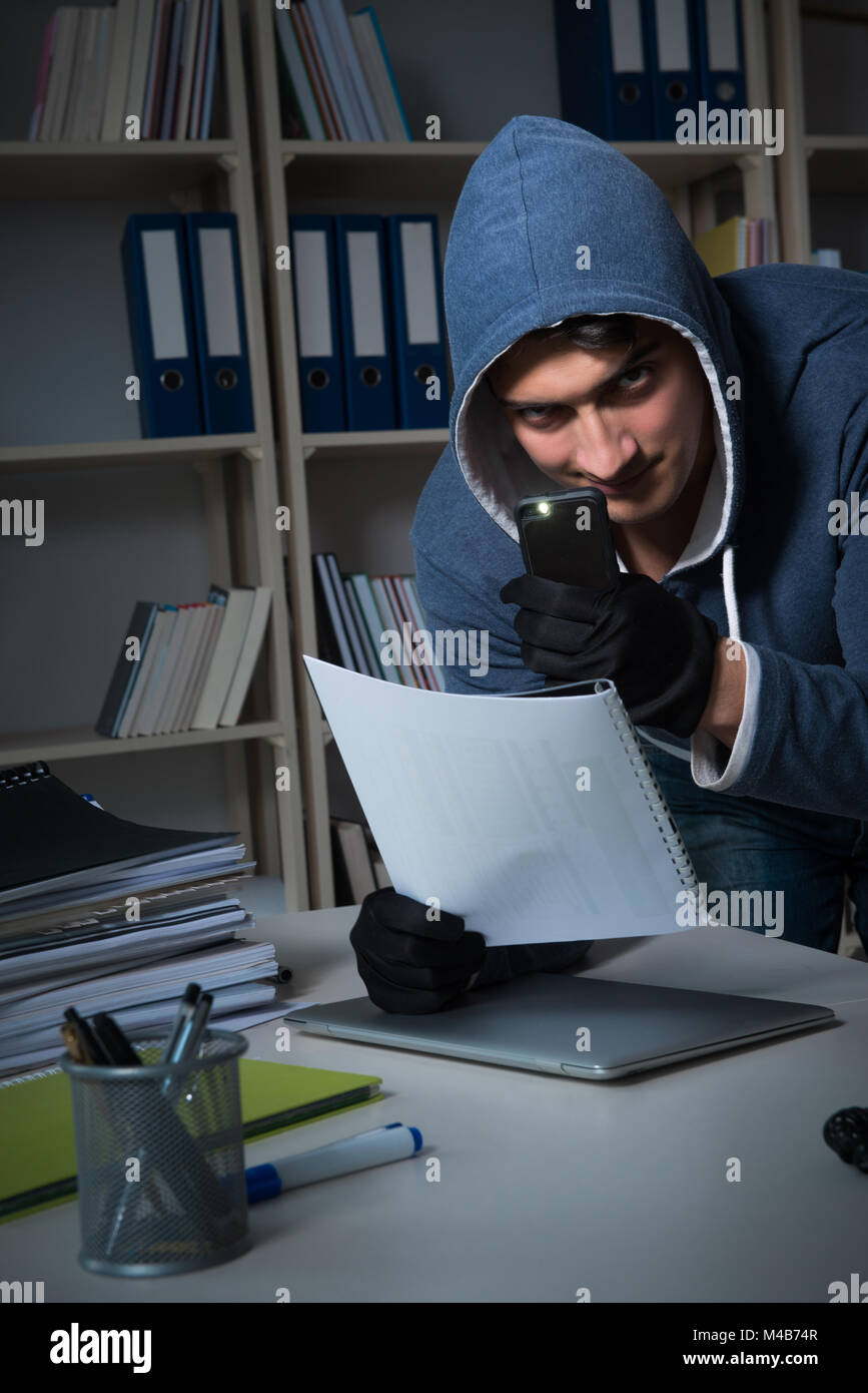 Young man in industrial espionage concept Stock Photo - Alamy