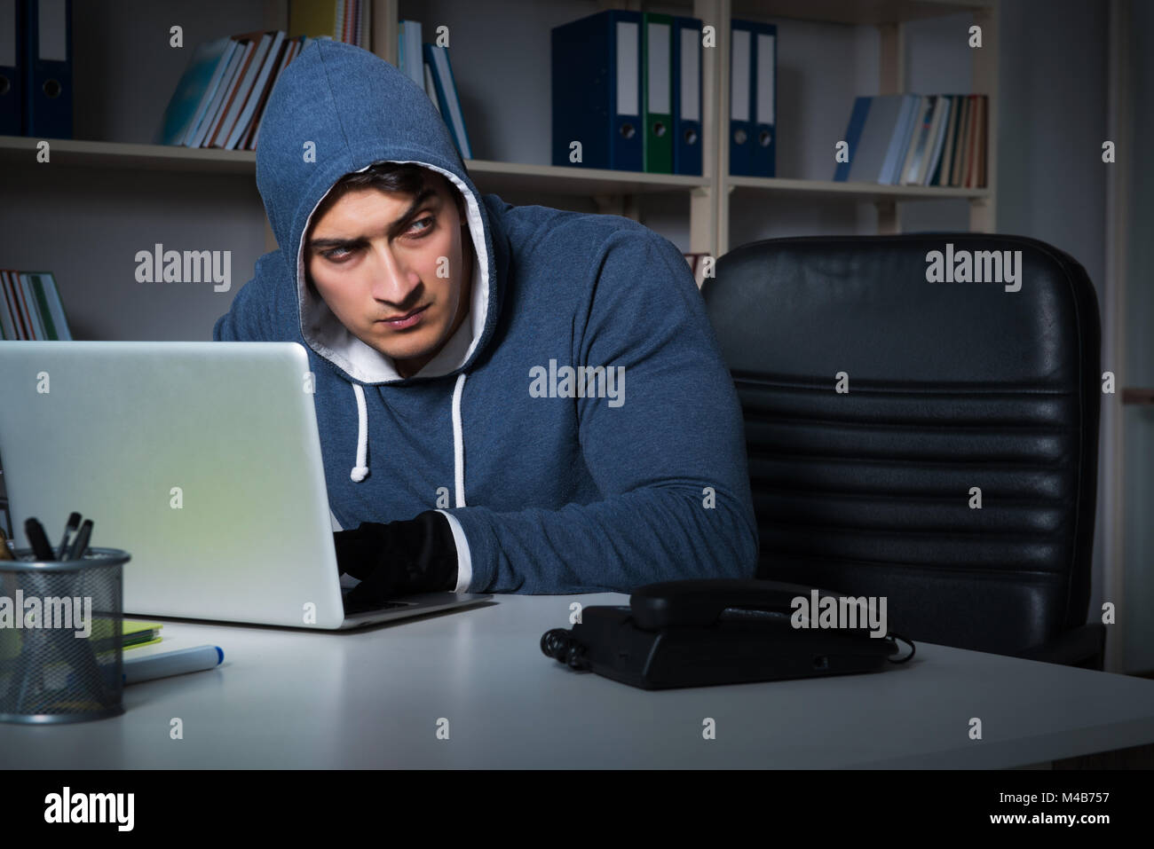 Young hacker hacking into computer at night Stock Photo - Alamy