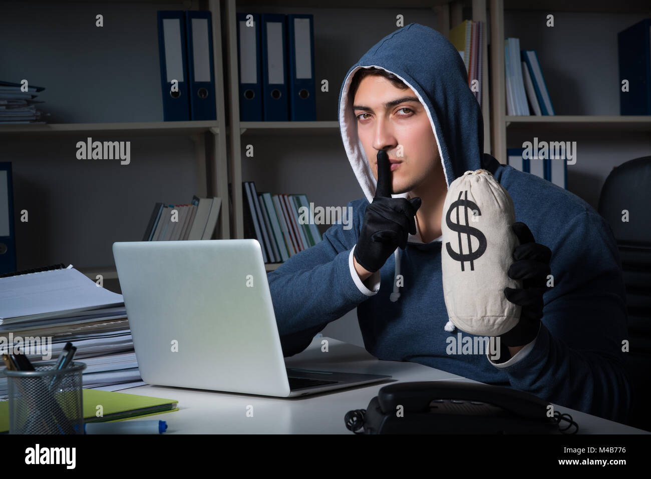 Young hacker hacking into computer at night Stock Photo - Alamy