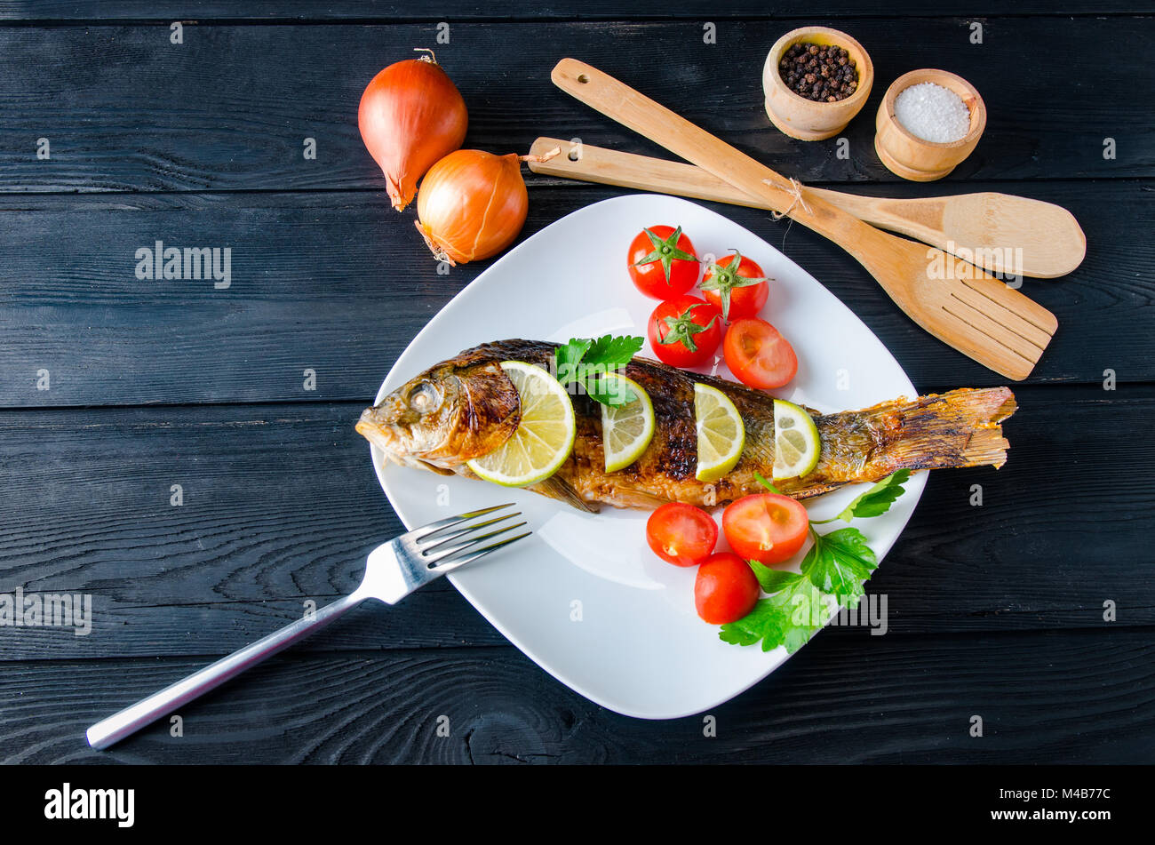 Fried fish served on the plate Stock Photo - Alamy