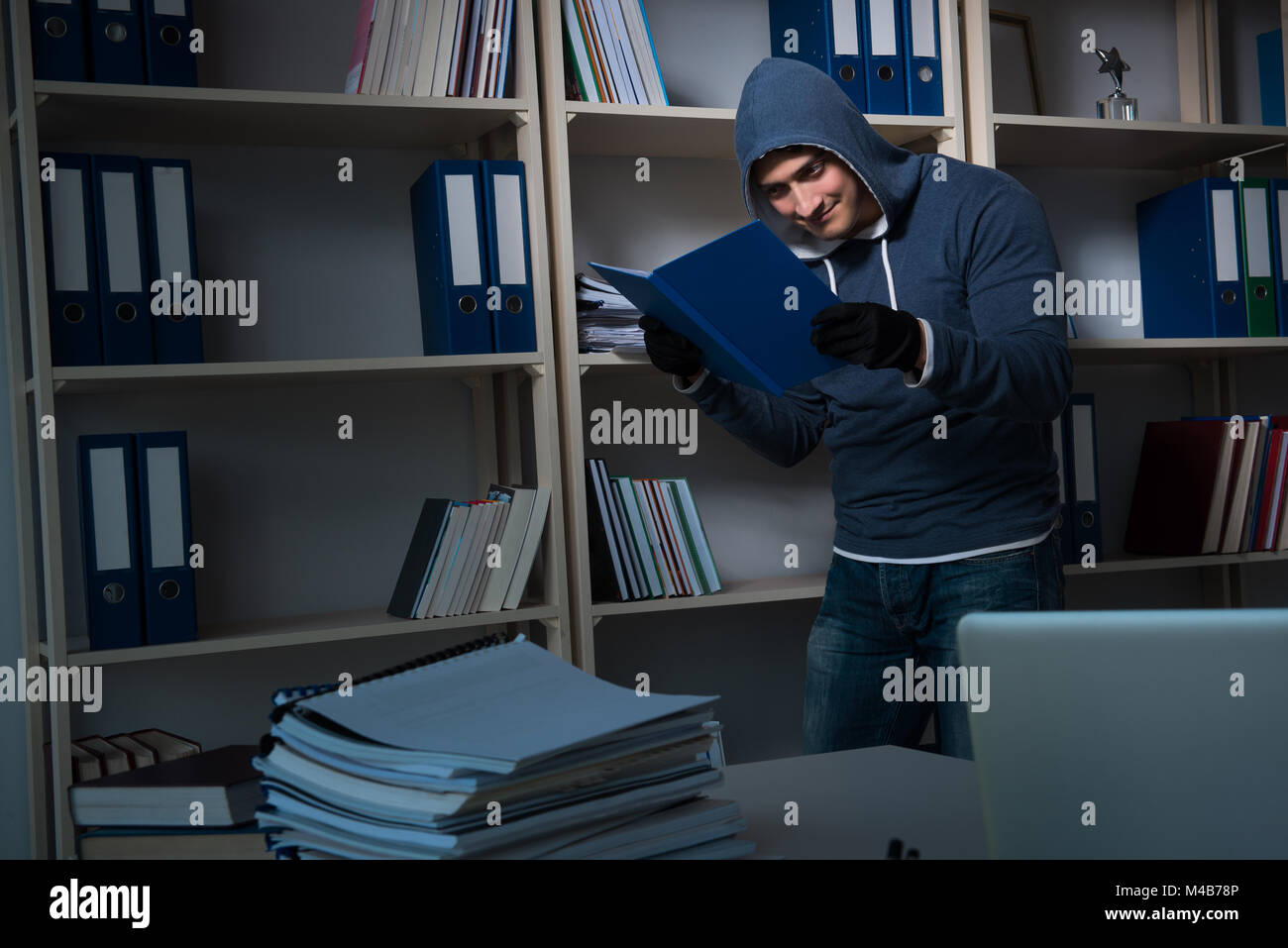 Young man in industrial espionage concept Stock Photo - Alamy