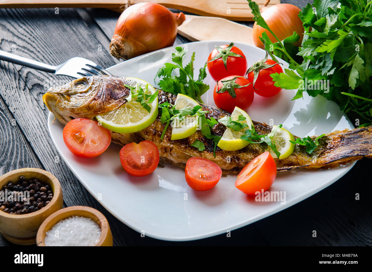 Fried fish served on the plate Stock Photo - Alamy