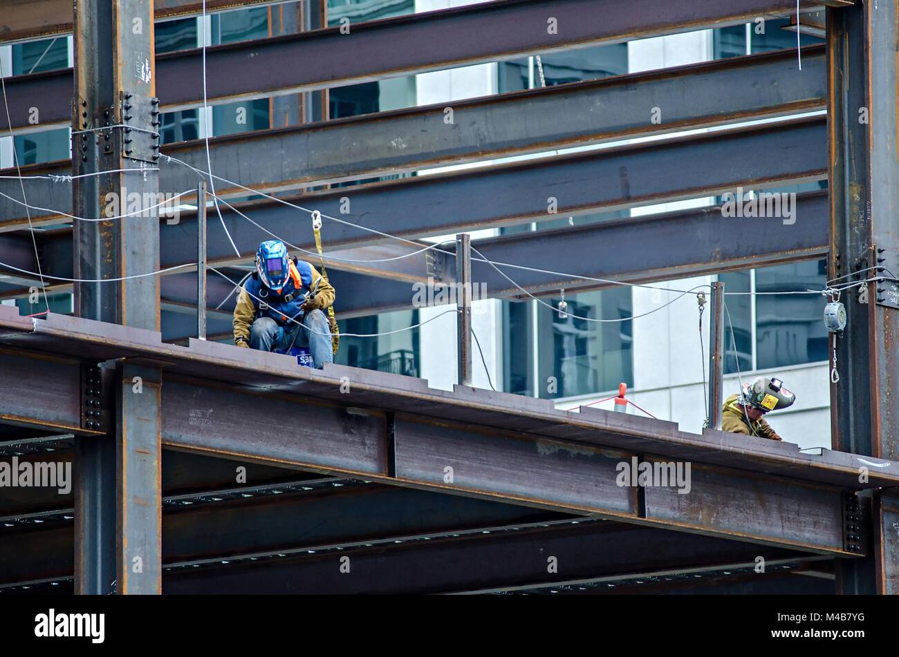 construction worker working on highrise building Stock Photo - Alamy