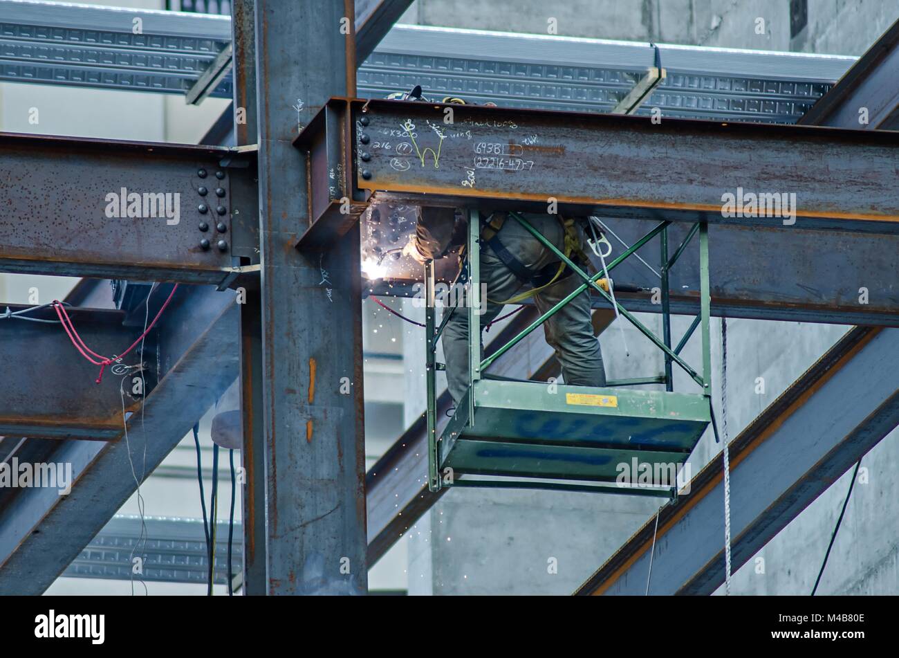 construction worker working on highrise building Stock Photo - Alamy