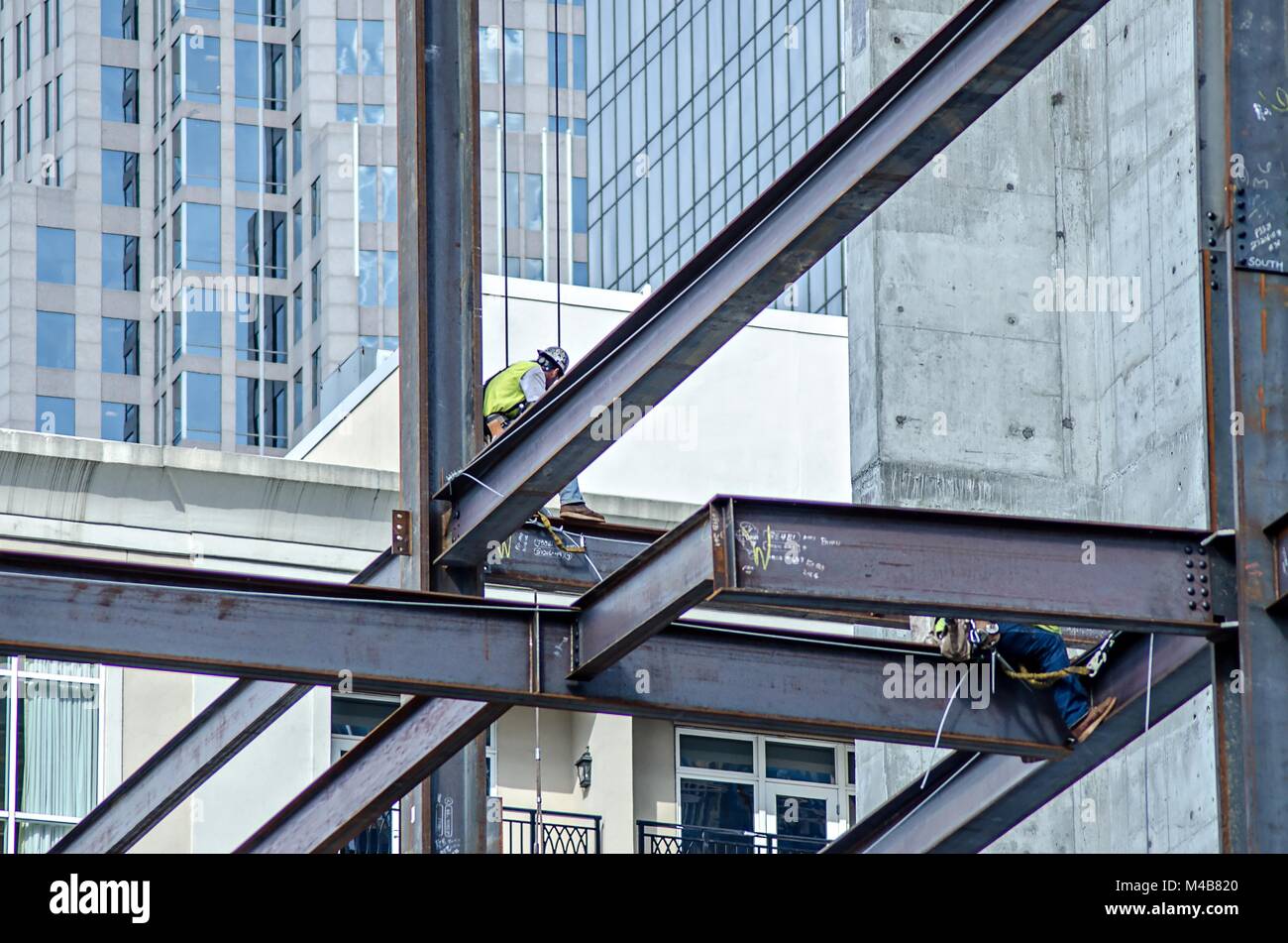 construction worker working on highrise building Stock Photo - Alamy