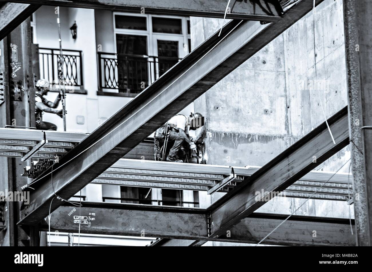 construction worker working on highrise building Stock Photo - Alamy
