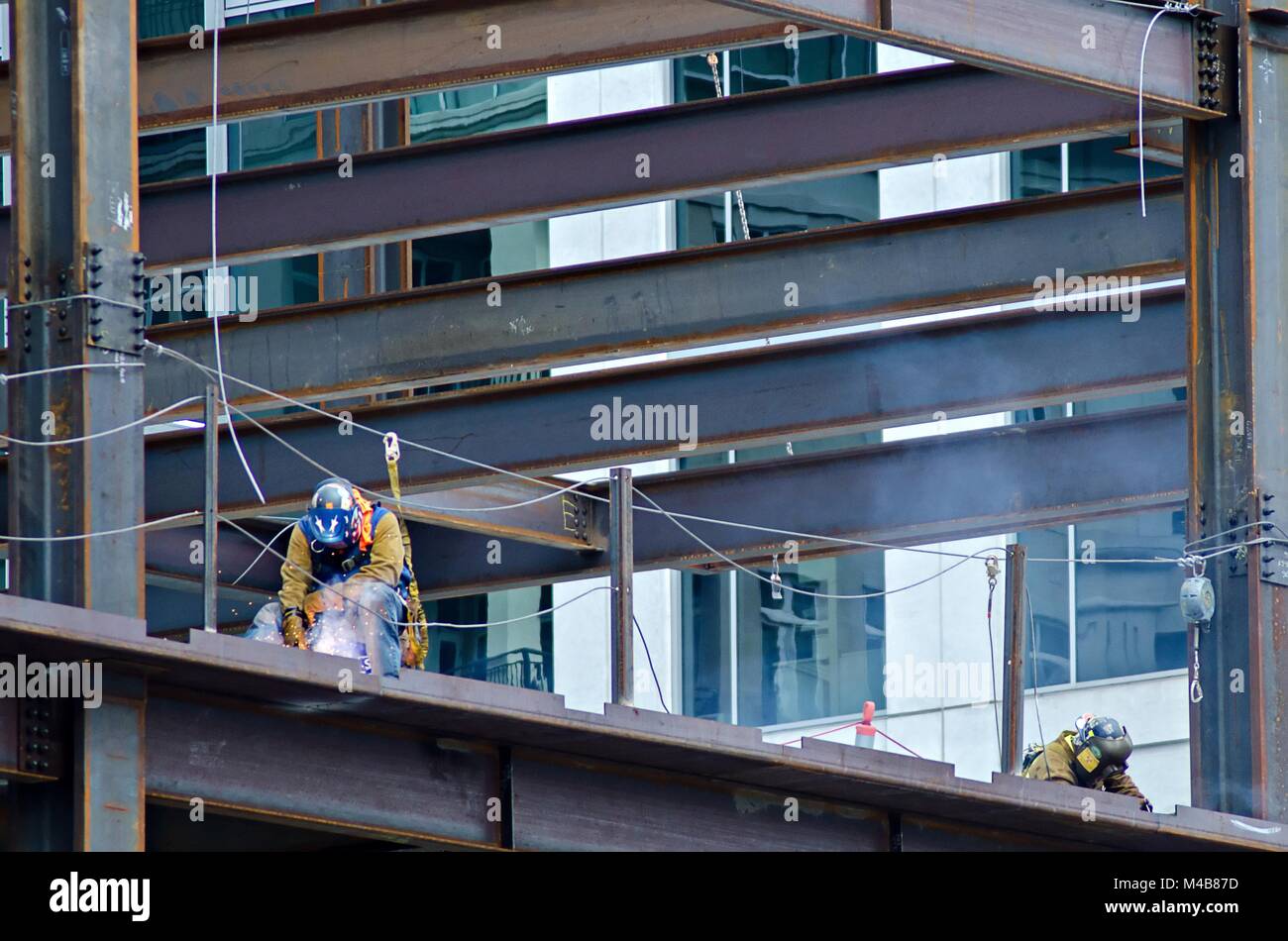 construction worker working on highrise building Stock Photo - Alamy