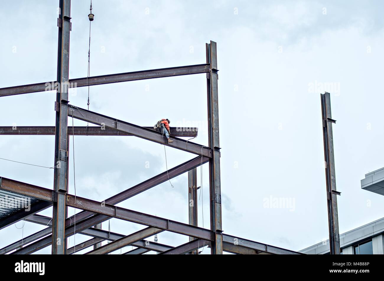 construction worker working on highrise building Stock Photo - Alamy