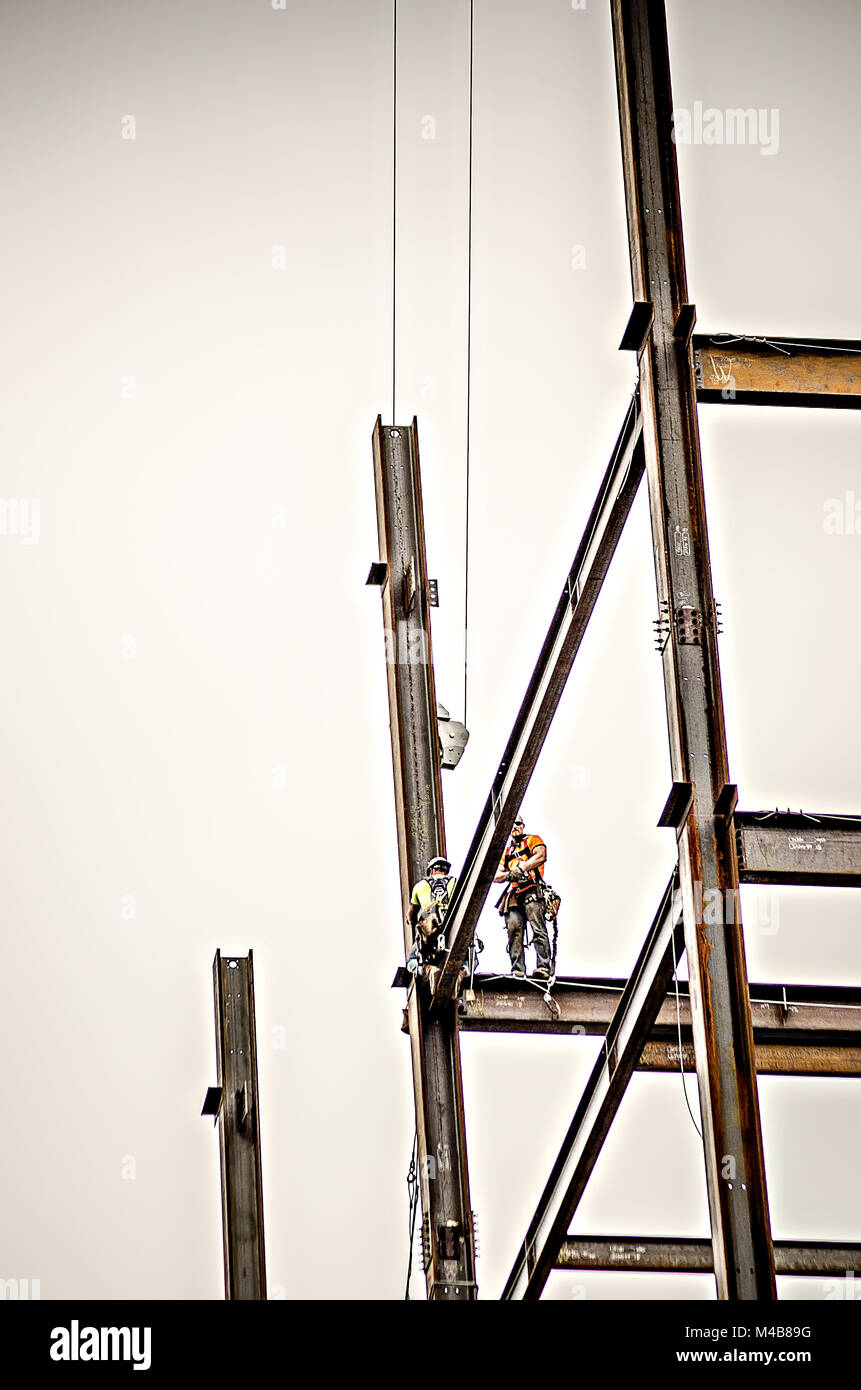 construction worker working on highrise building Stock Photo - Alamy