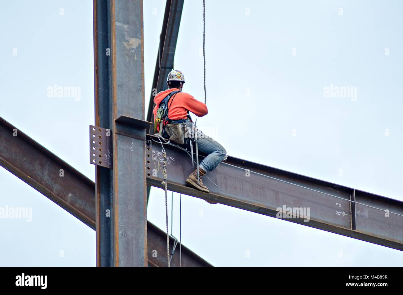 construction worker working on highrise building Stock Photo - Alamy
