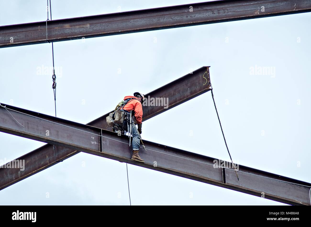 construction worker working on highrise building Stock Photo - Alamy