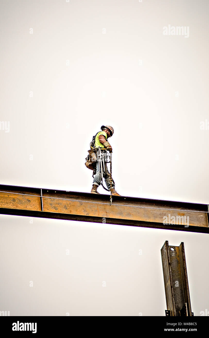 construction worker working on highrise building Stock Photo - Alamy