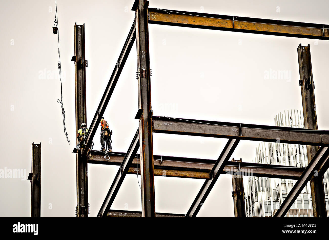 construction worker working on highrise building Stock Photo - Alamy