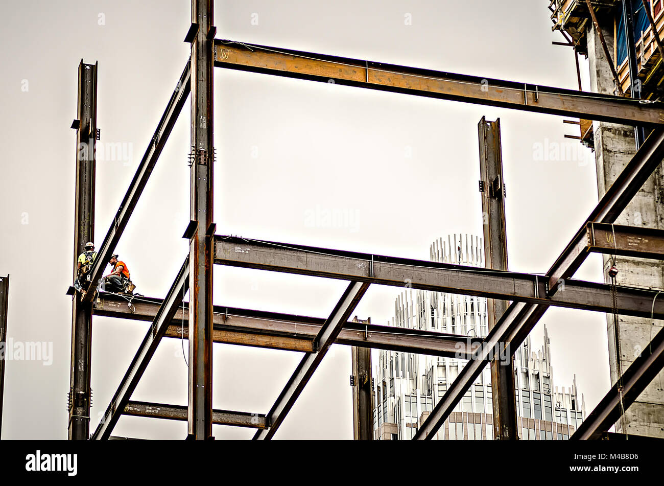 construction worker working on highrise building Stock Photo - Alamy