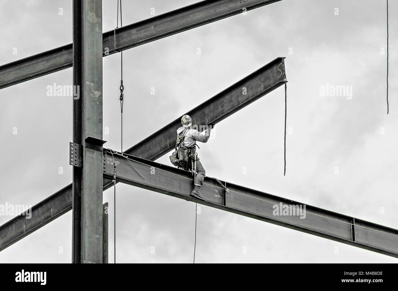 construction worker working on highrise building Stock Photo - Alamy