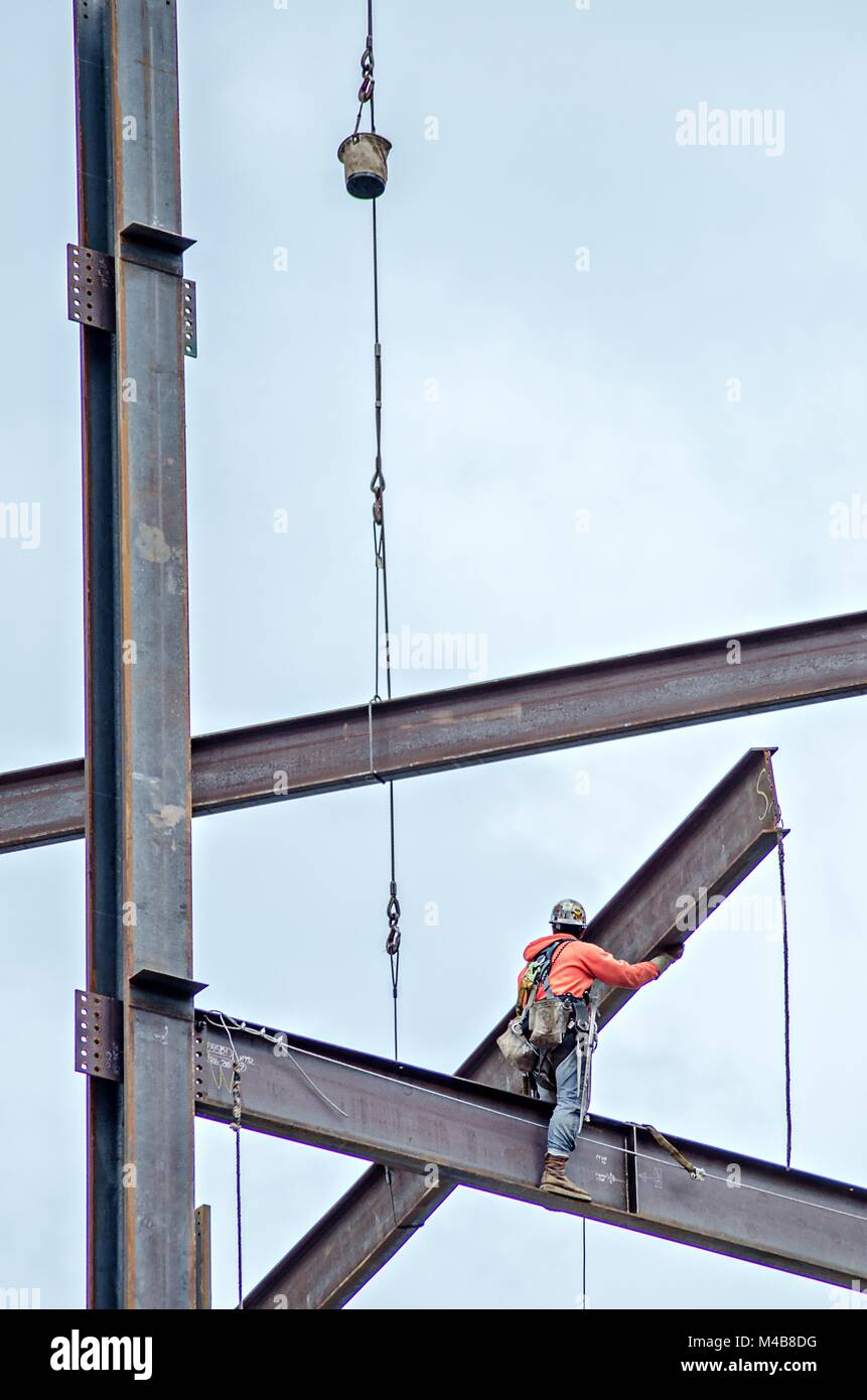 construction worker working on highrise building Stock Photo - Alamy