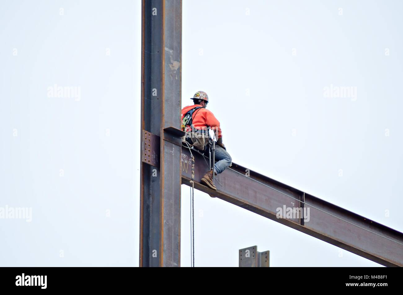 construction worker working on highrise building Stock Photo - Alamy