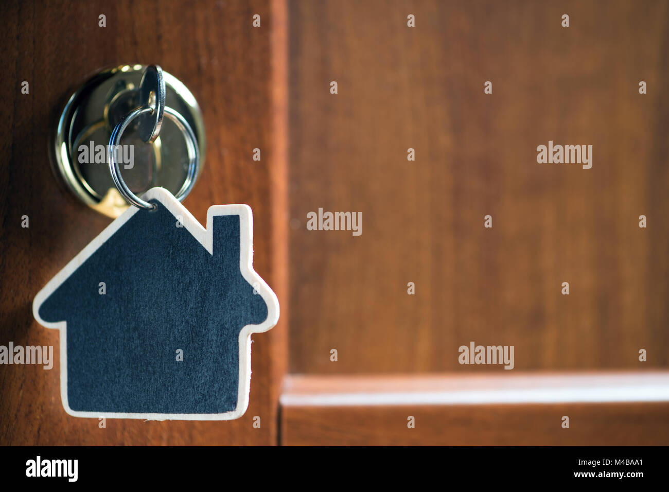 House shape with a key in house door Stock Photo - Alamy