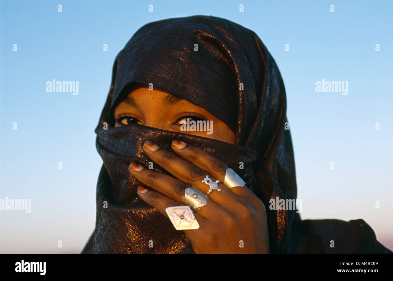 Algeria. Near Djanet. Sahara desert. Veiled woman of Tuareg tribe ...