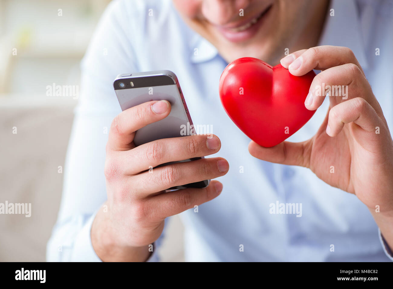 Young man chatting with his sweetheart over mobile phone Stock Photo ...