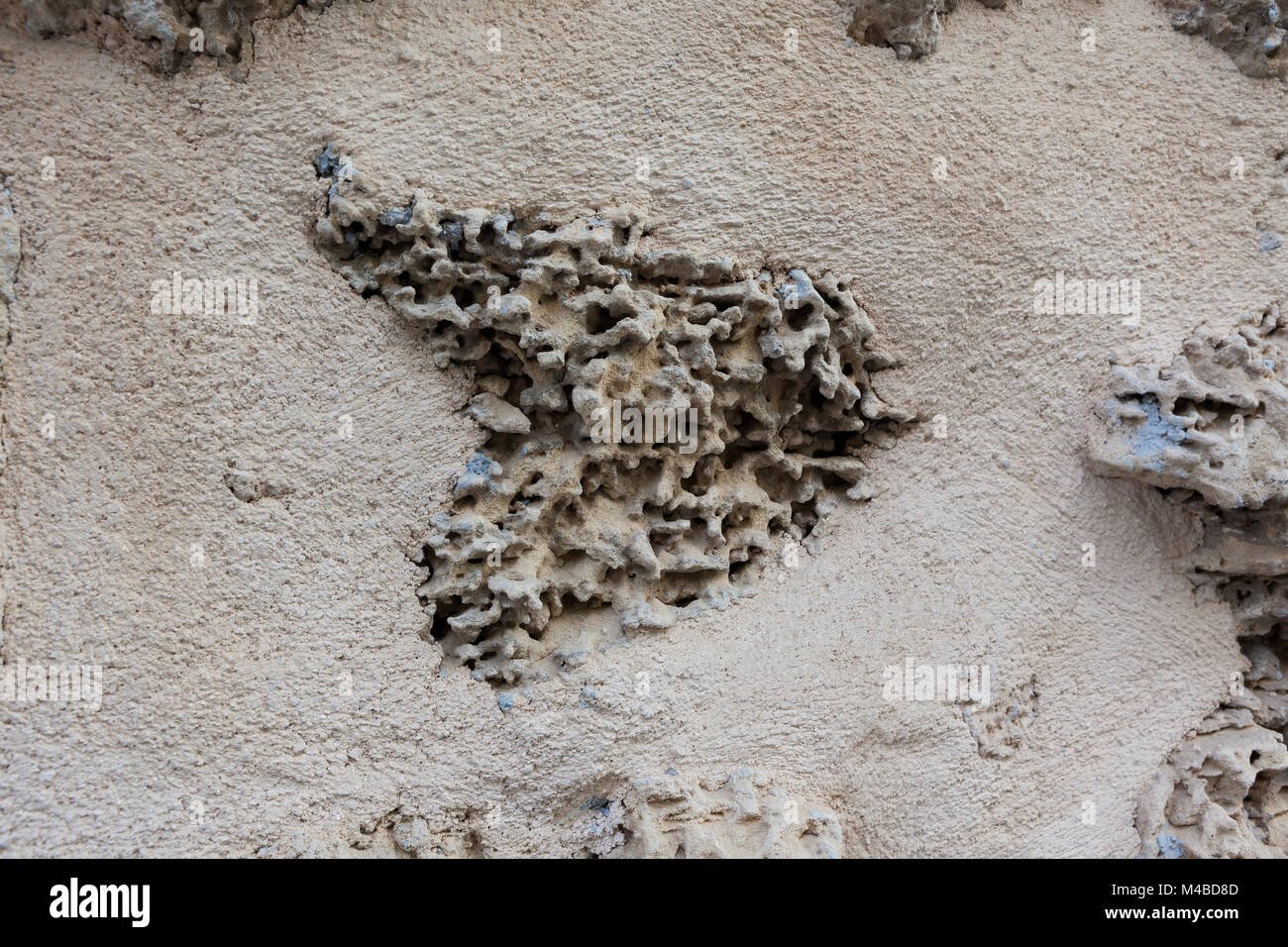 Fragment of rough sand colour stone wall background Stock Photo - Alamy