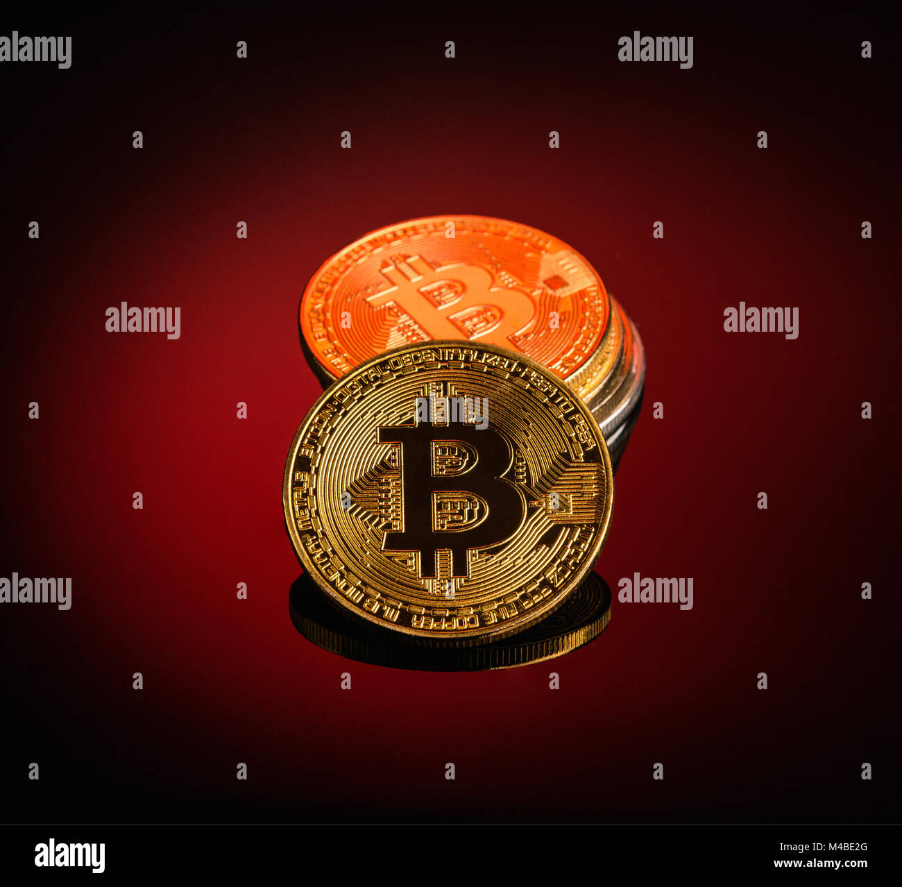 Stack of bitcoins on dark red background Stock Photo - Alamy