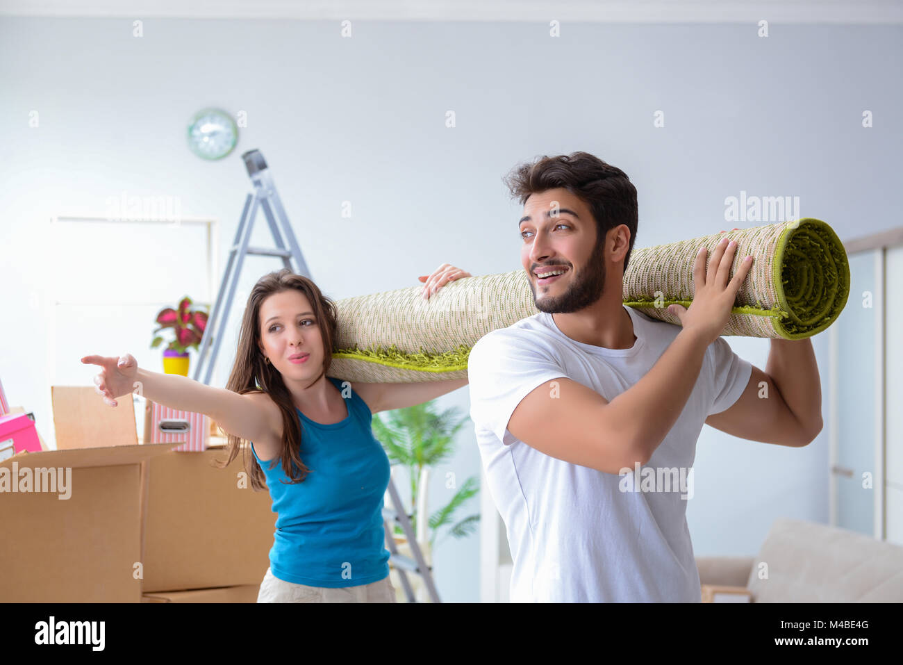 Young family unpacking at new house with boxes Stock Photo - Alamy