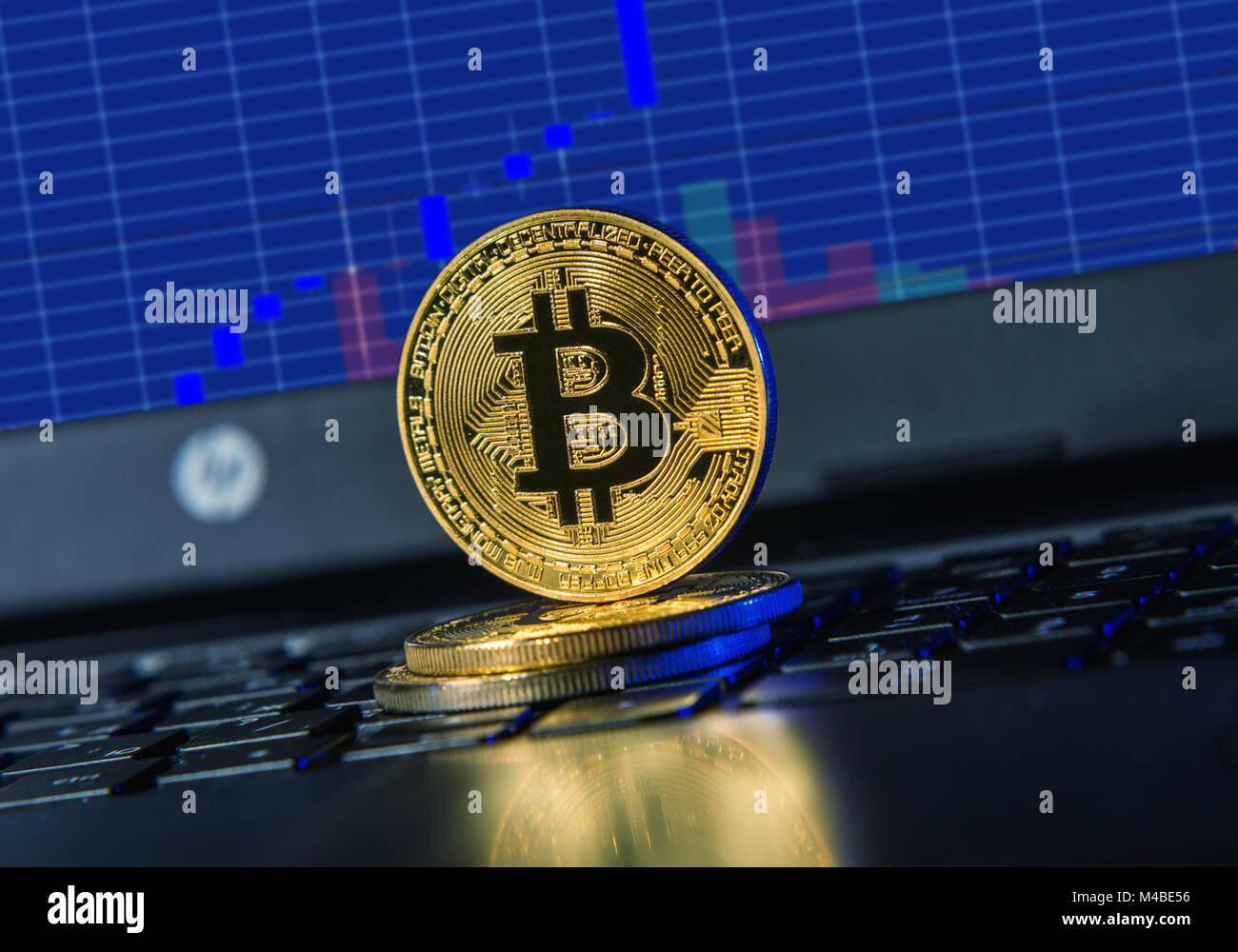 Golden bitcoin on keyboard against currency chart on pc screen Stock ...