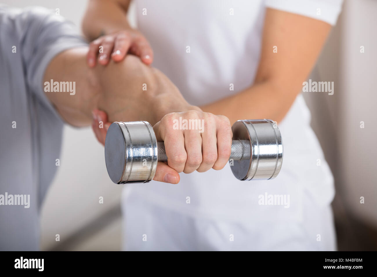 Female Physiotherapist Helping Patient Exercise Hi Res Stock