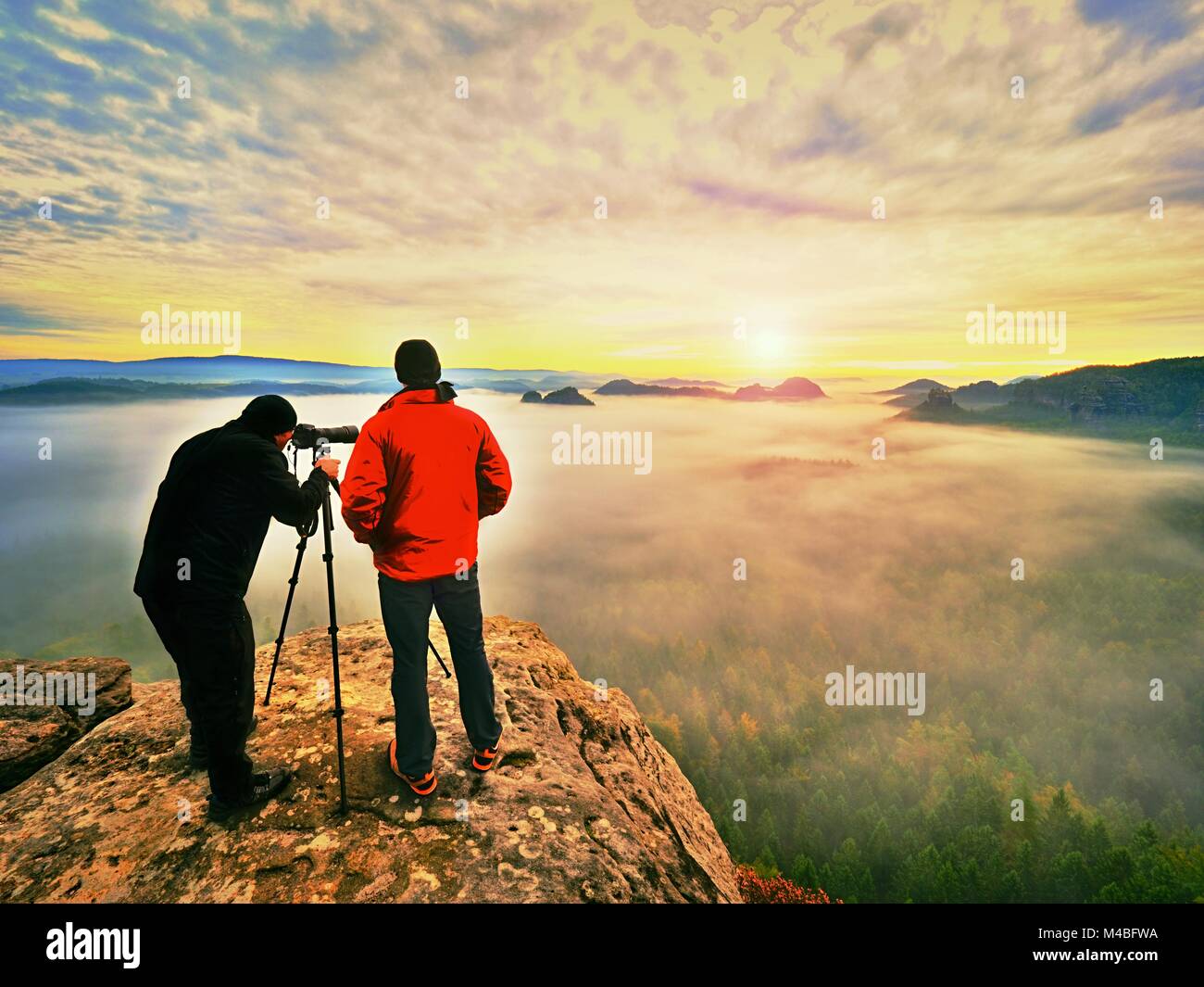 Two men enjoy photographying in wild nature. Nature photographer with ...