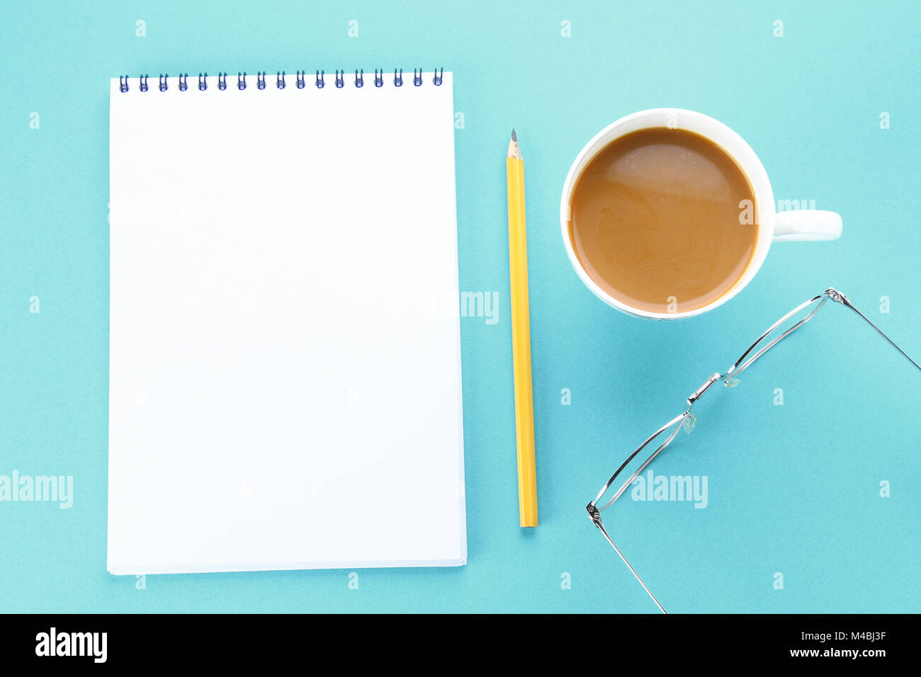 Top view image of open notebook with blank pages and coffee on blue ...