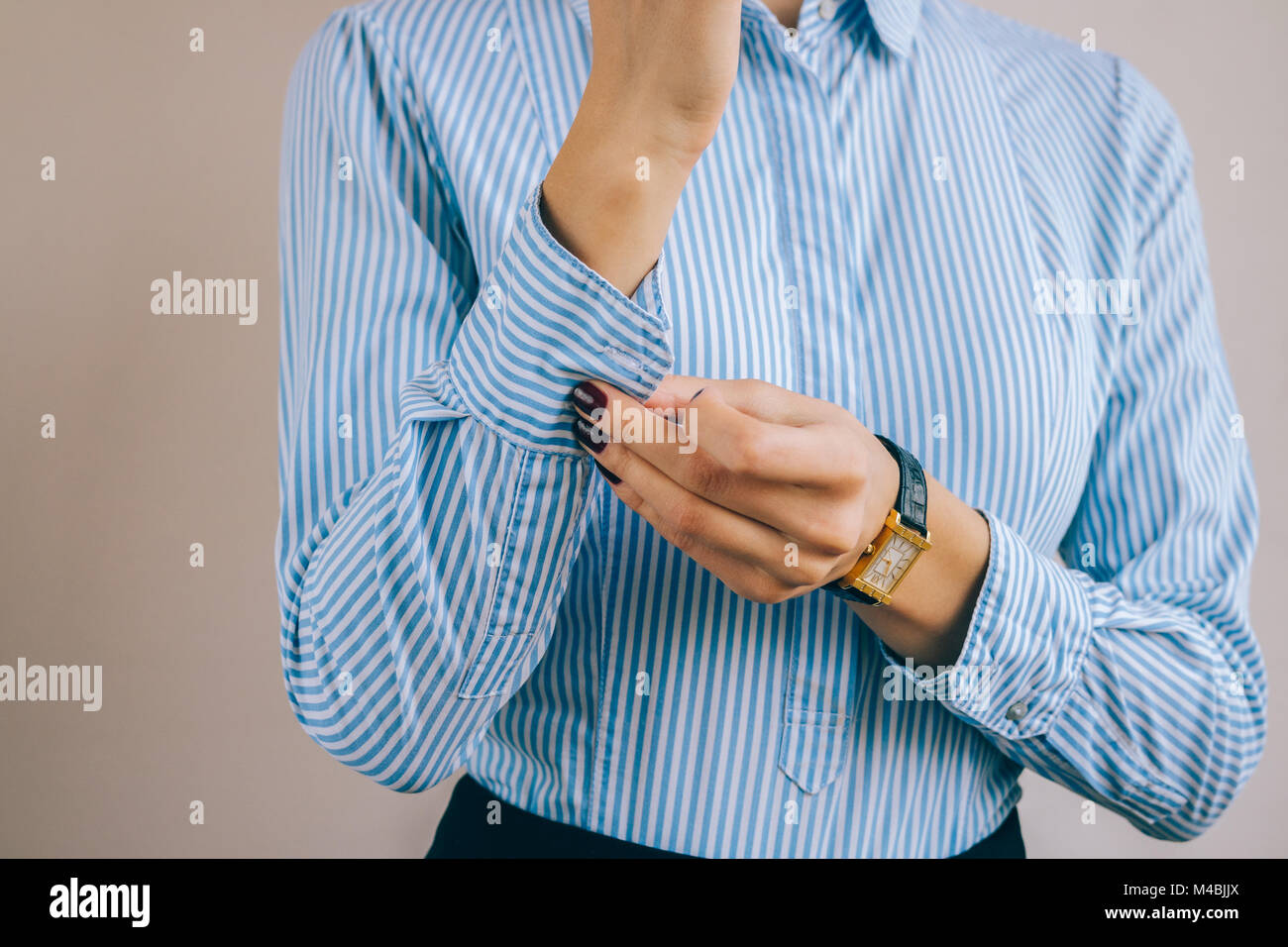 Woman buttoning up blouse hi-res stock photography and images - Alamy