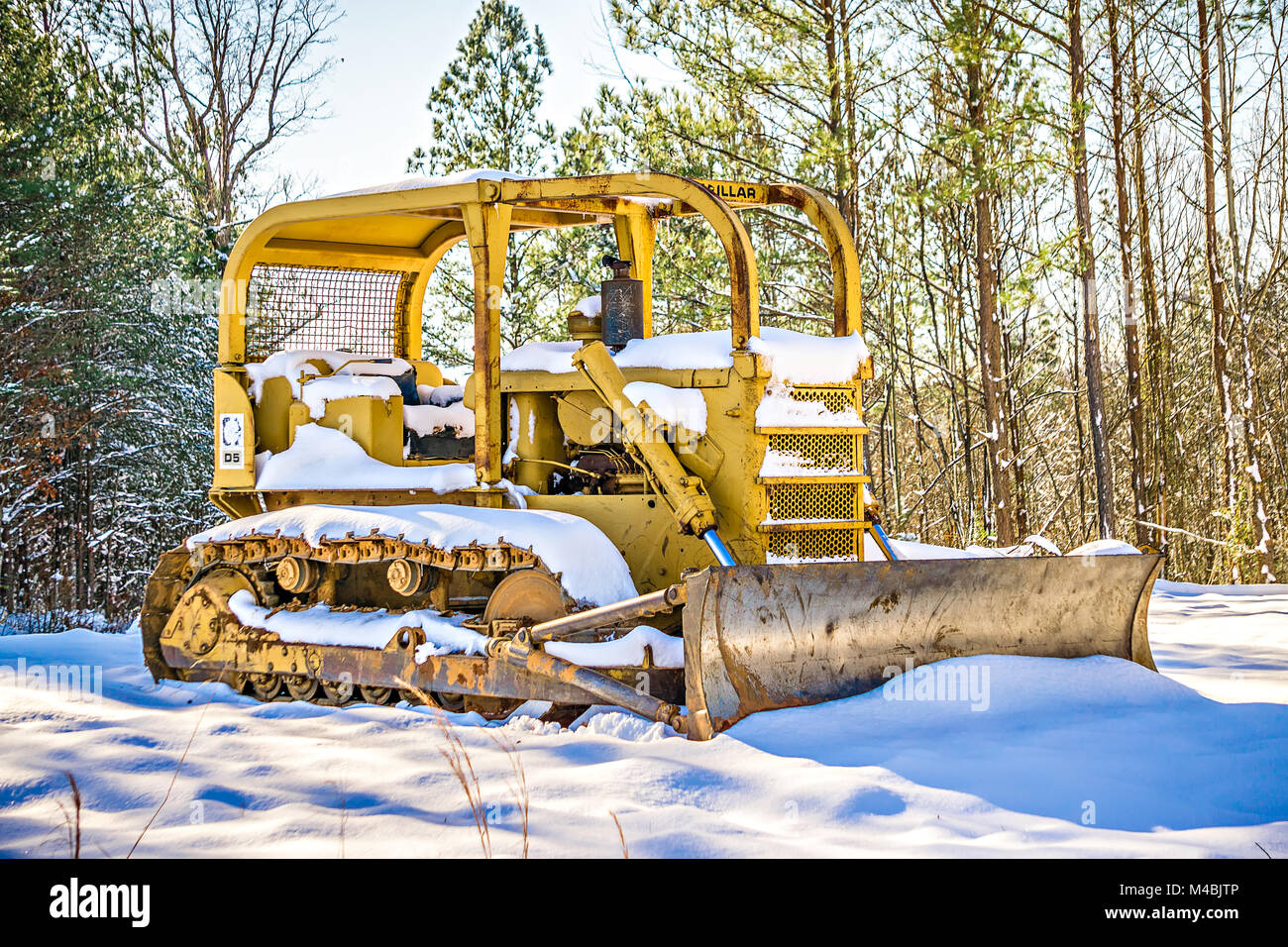 bulldozer at construction site covered with snow Stock Photo - Alamy