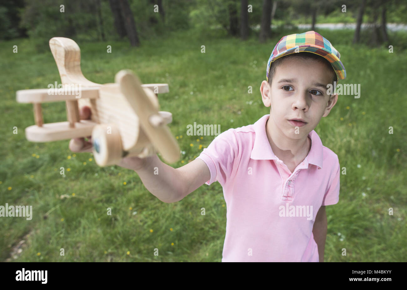 Child play with a wooden plane in the mountain Stock Photo - Alamy