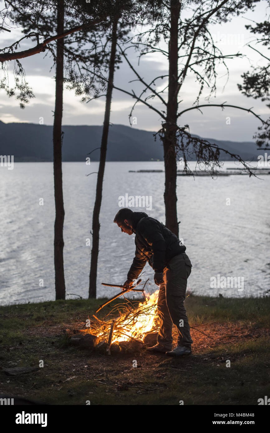 Man lights fire in hi-res stock photography and images - Alamy