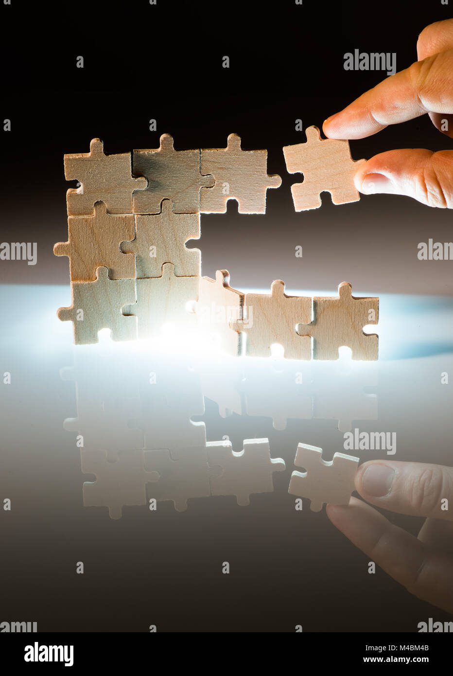 Wooden puzzle and backlight background. Close up Stock Photo - Alamy