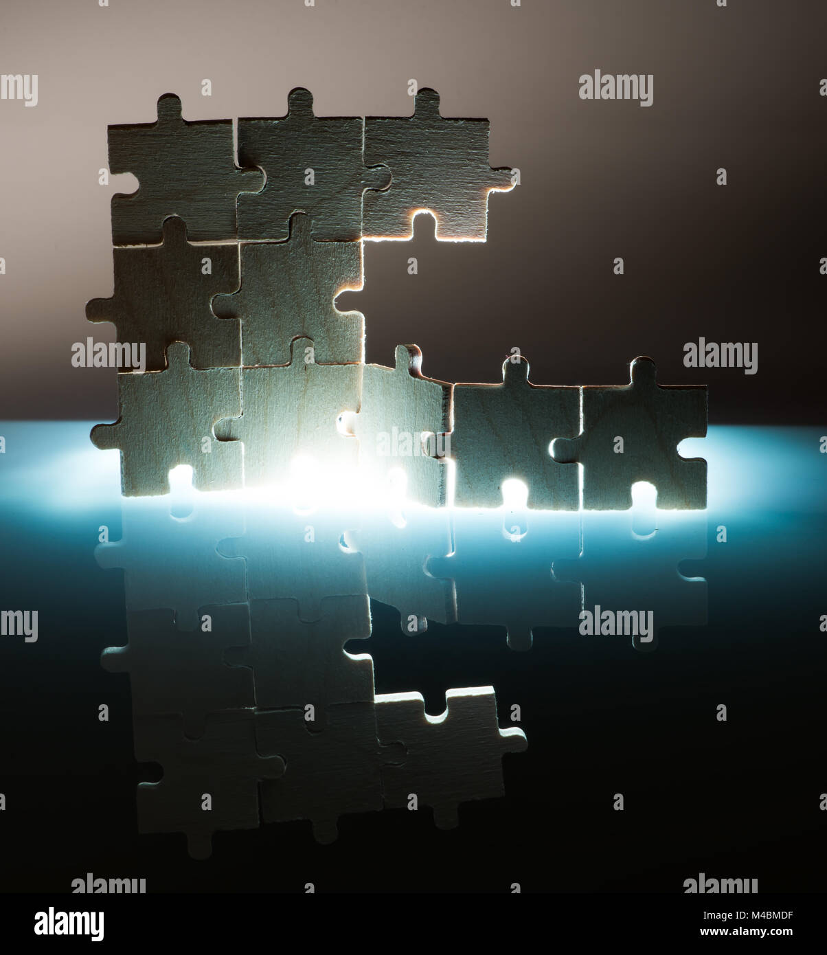 Wooden puzzle and backlight background. Close up Stock Photo - Alamy