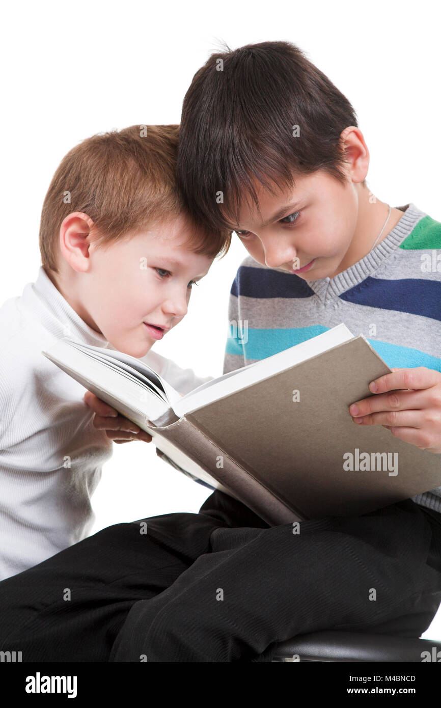 Two boys reading big book Stock Photo - Alamy