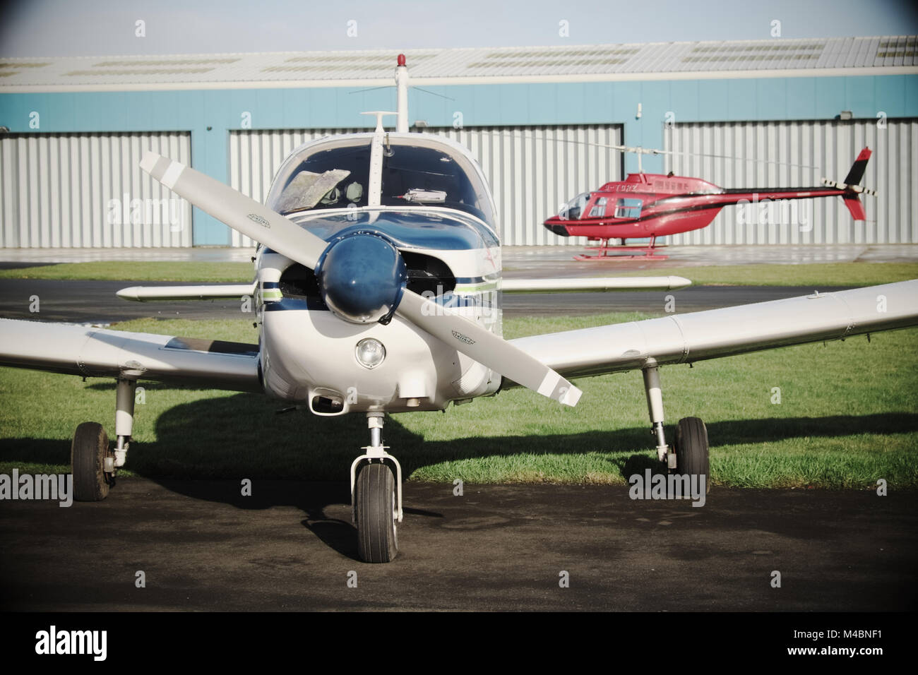 General aviation flying club aircraft and helicopter at airfield Stock ...