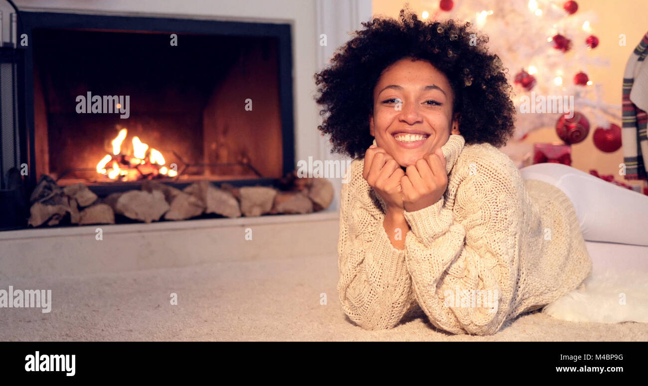 Woman by fireplace and wearing warm sweater Stock Photo - Alamy