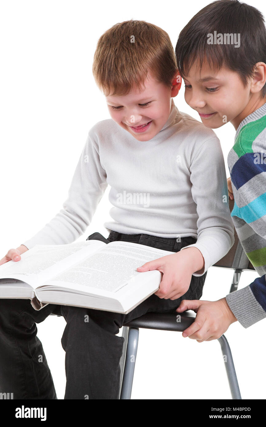 Two boys reading big book Stock Photo - Alamy