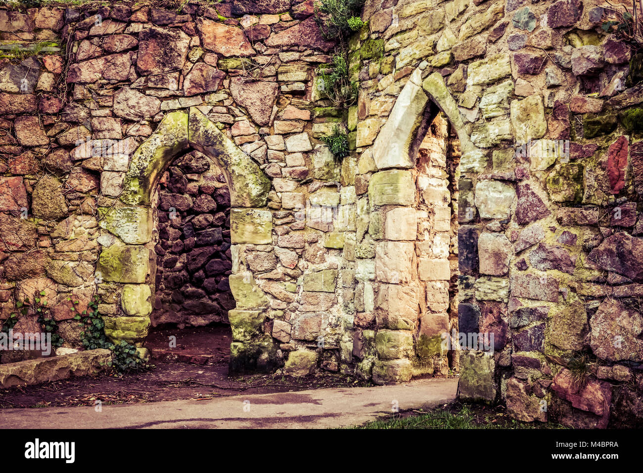 Weathered stone arches of an ancient ruin, capturing the timeless ...