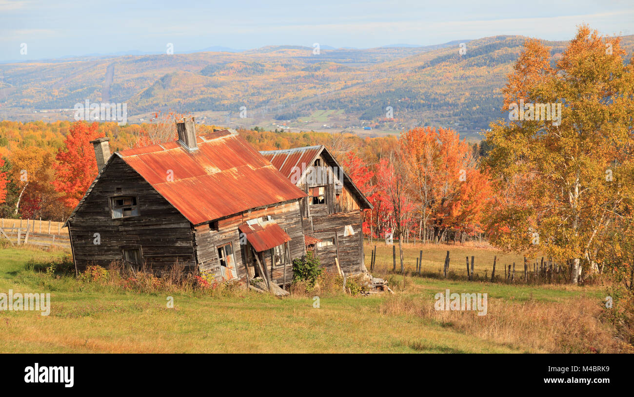 An old left farm in Canada before autumnal landscape Stock Photo - Alamy