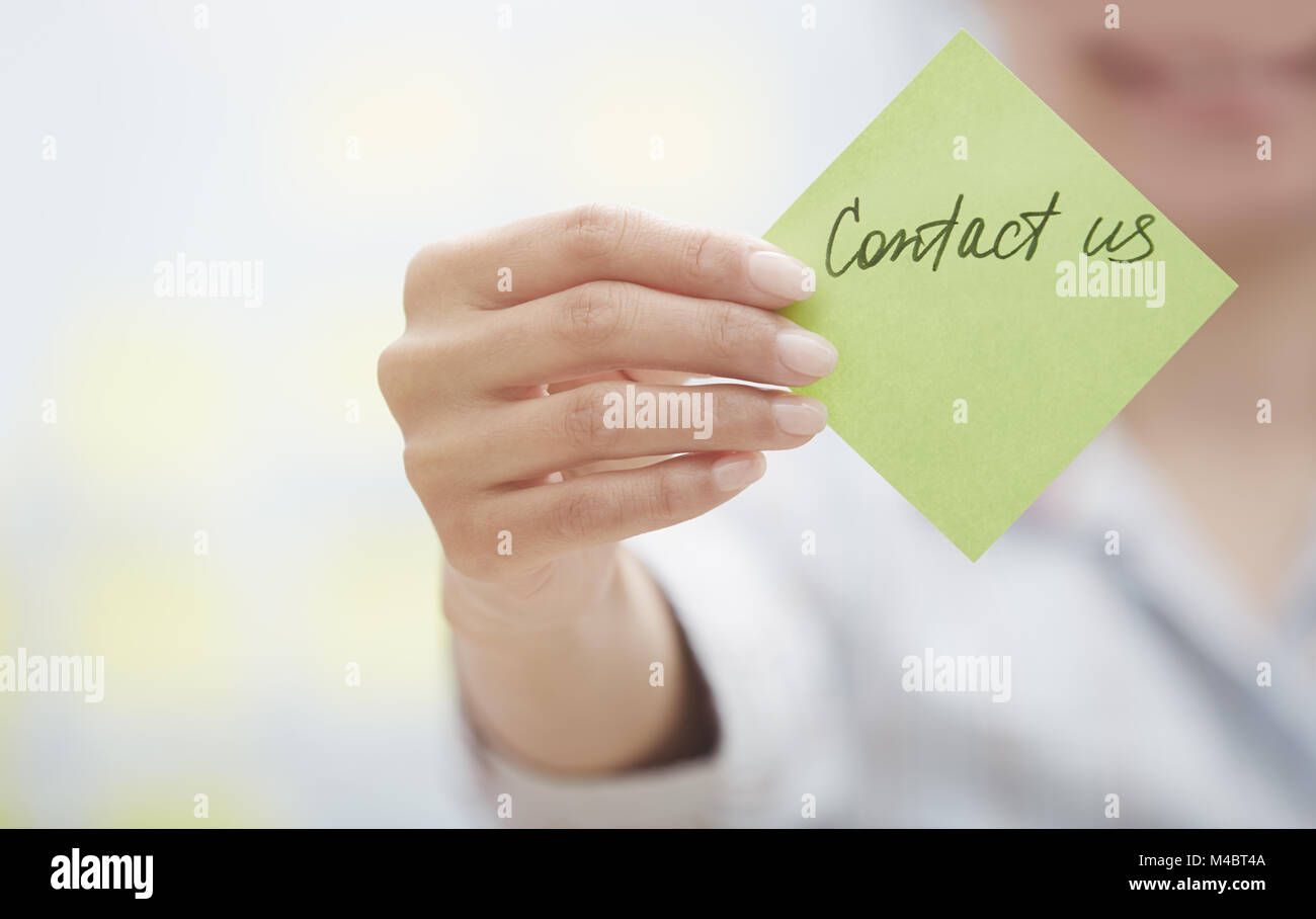 Contact us on adhesive note Stock Photo - Alamy