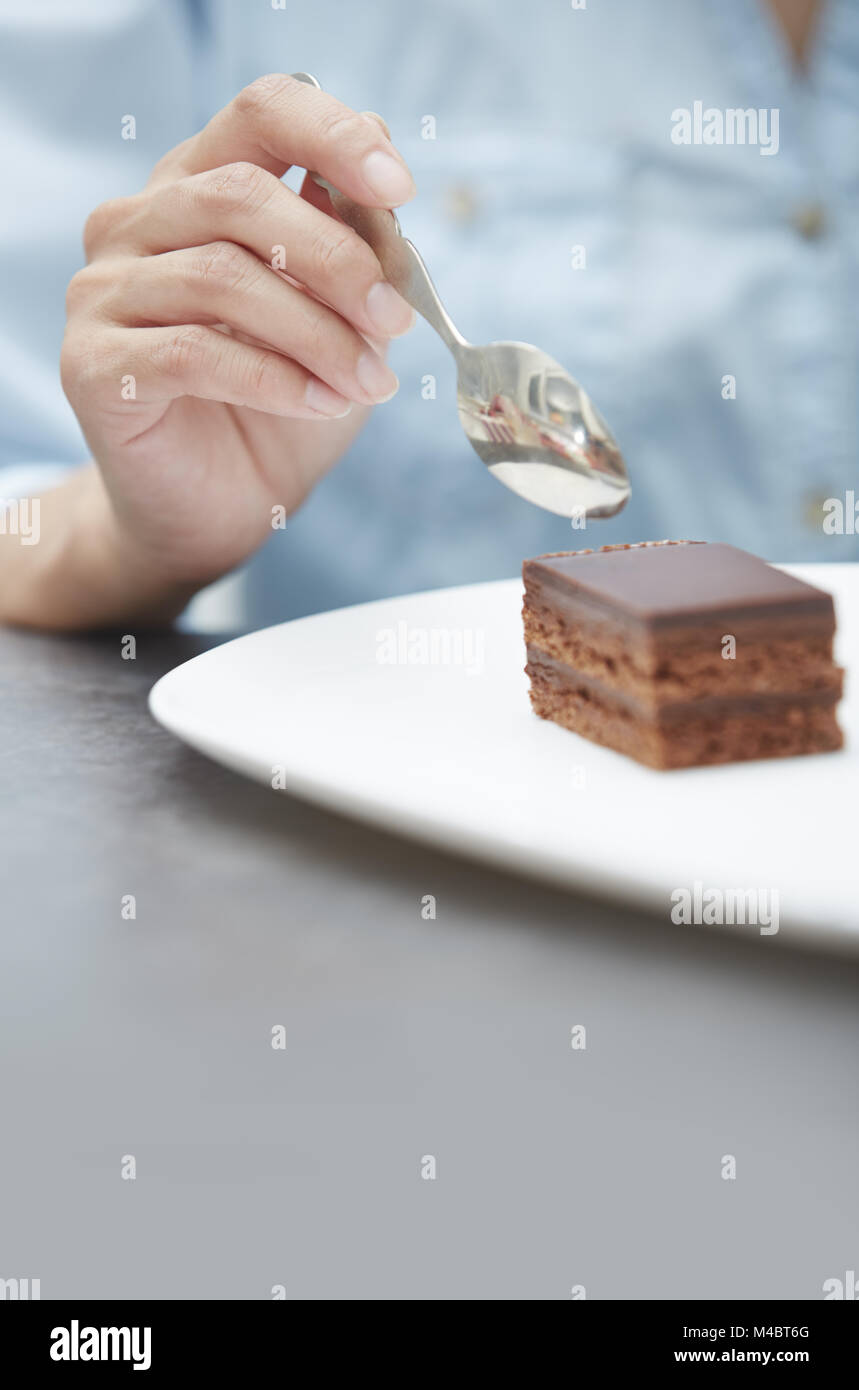 Woman eating chocolate cake Stock Photo - Alamy