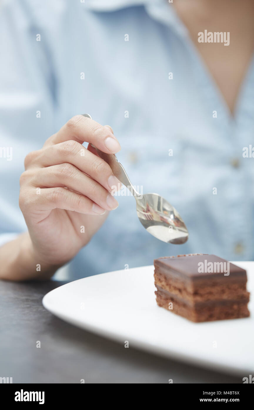 Woman eating chocolate cake Stock Photo - Alamy