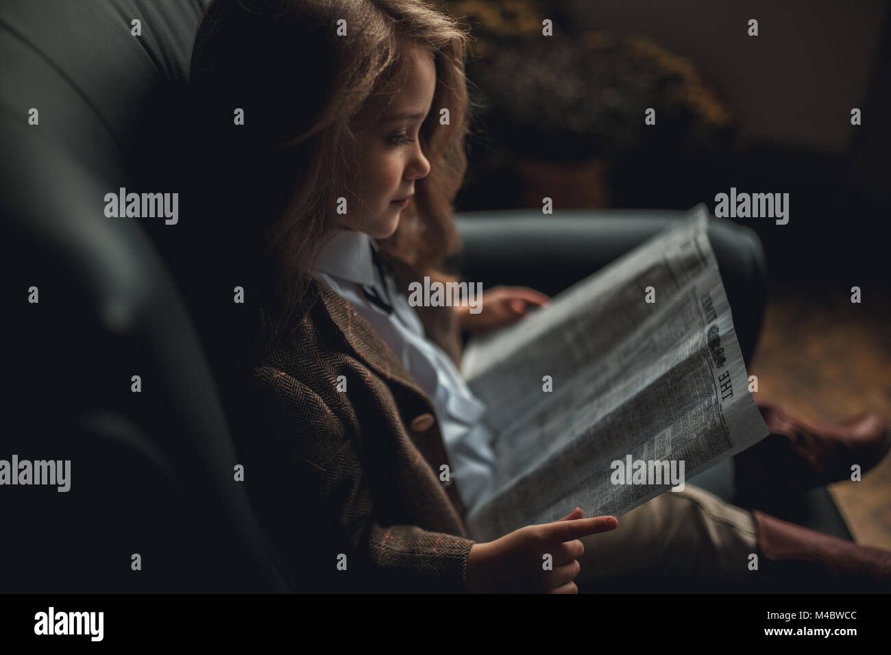 Child reading newspaper hi-res stock photography and images - Alamy