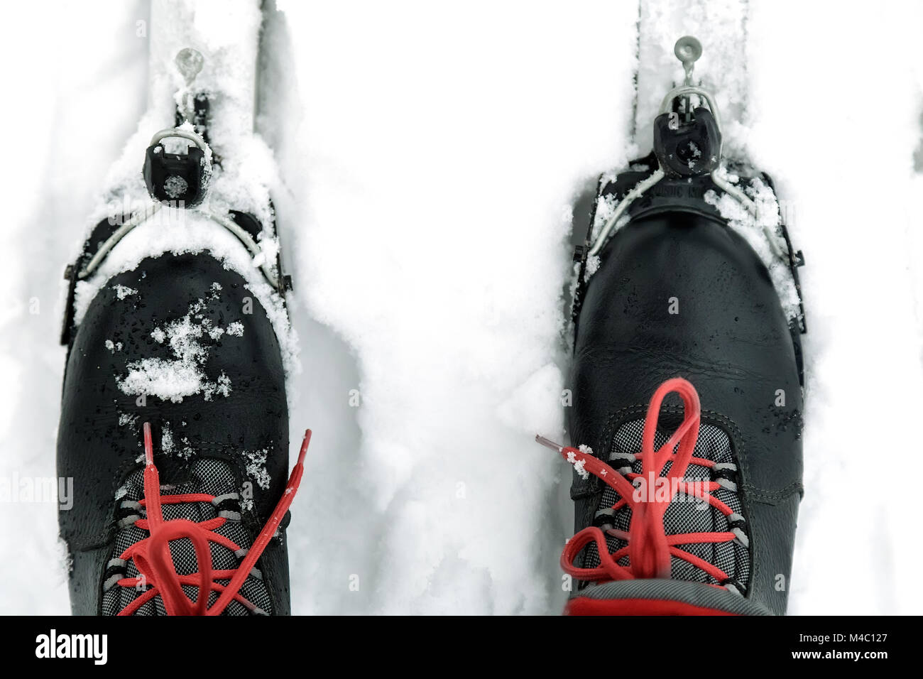 Ski boots and skis in the snow Stock Photo - Alamy